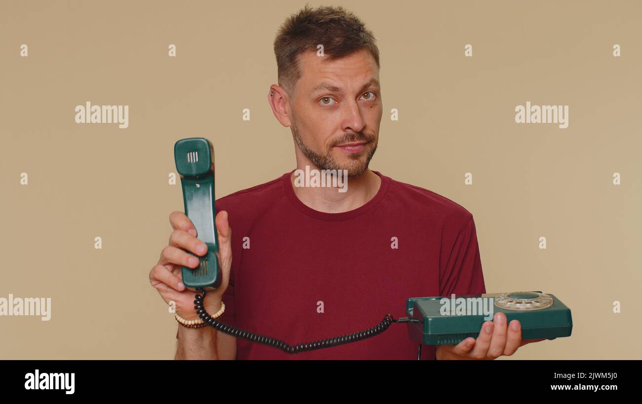 Hey you, call me back. Handsome young man in red t-shirt talking on ...