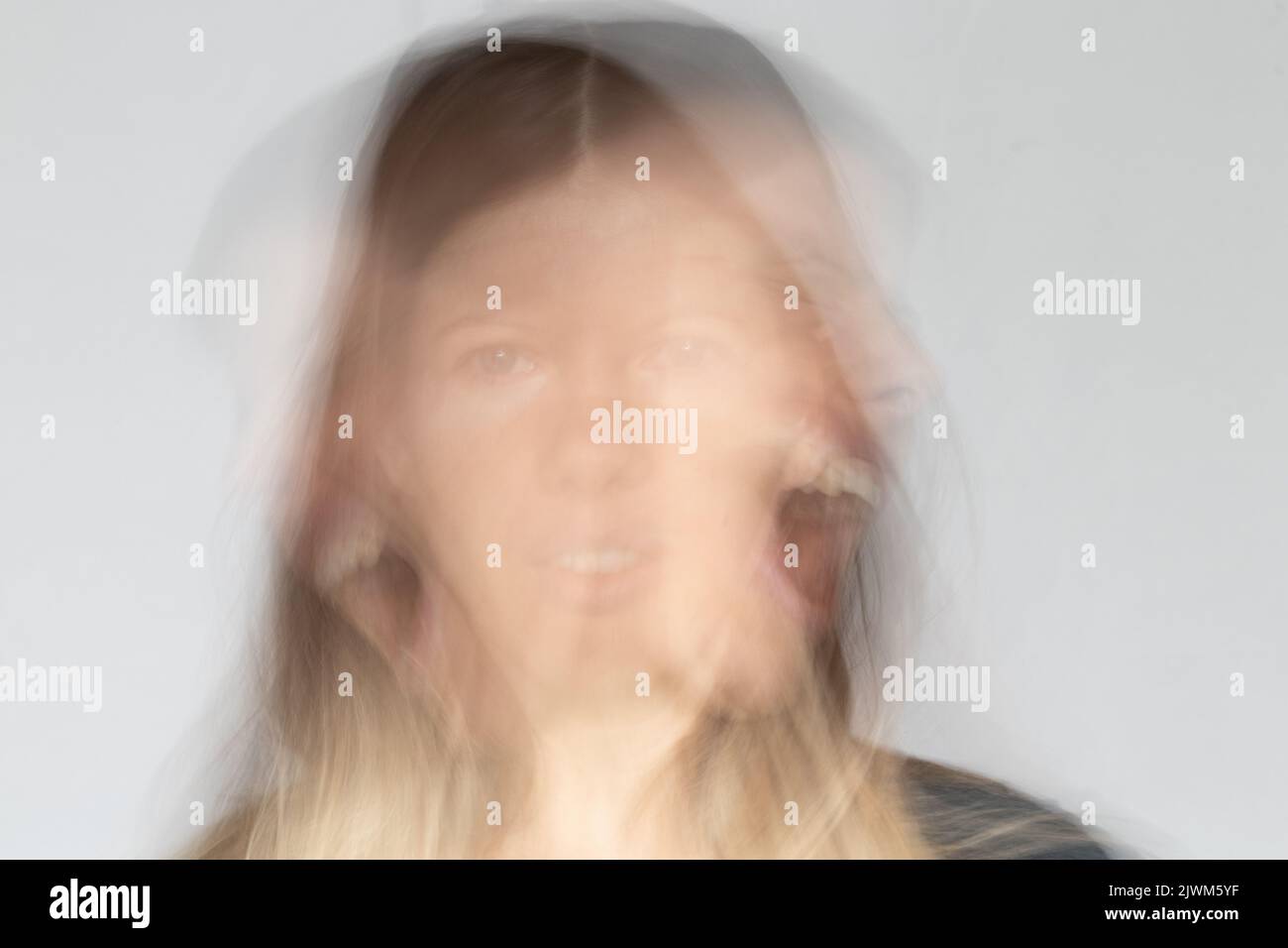 Long exposure photo with a screaming and hysterical head of a girl on ...