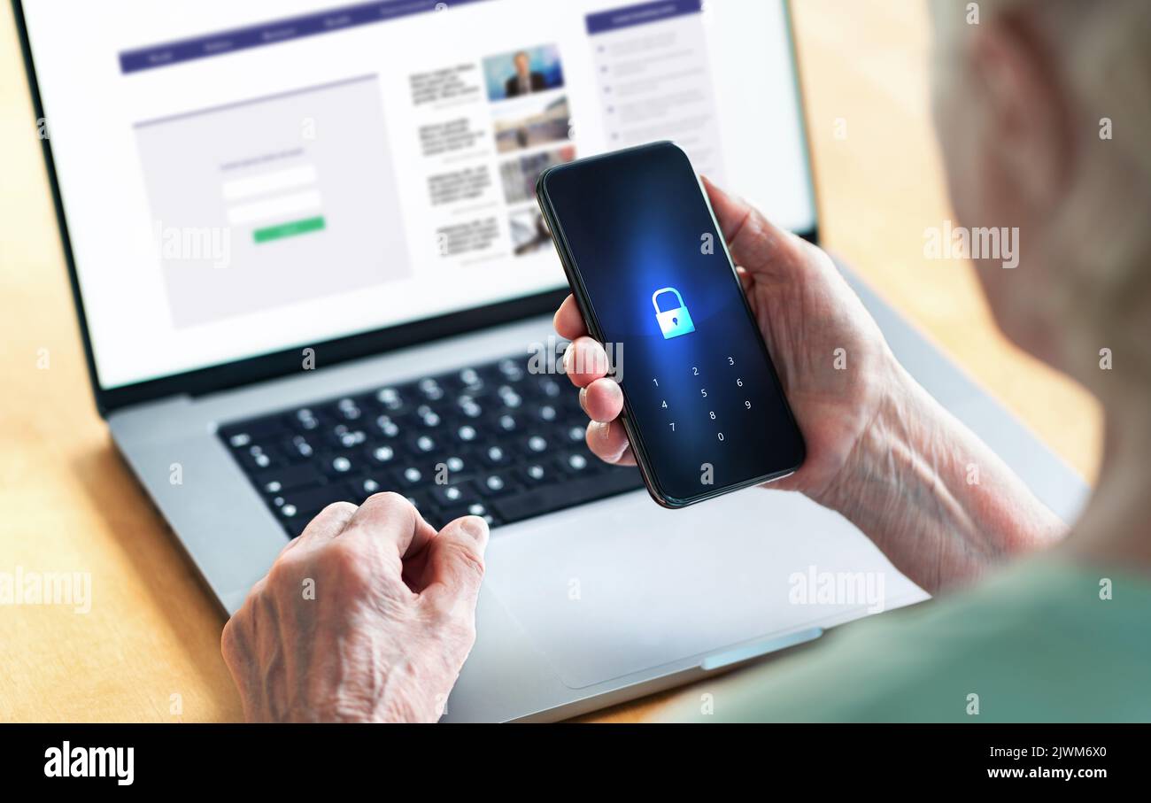 Senior and phone with lock password to protect data in online bank ...