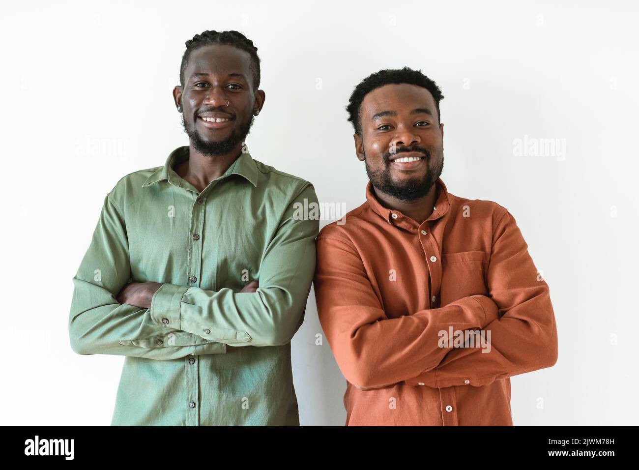 Two men standing crossing arms hi-res stock photography and images - Alamy
