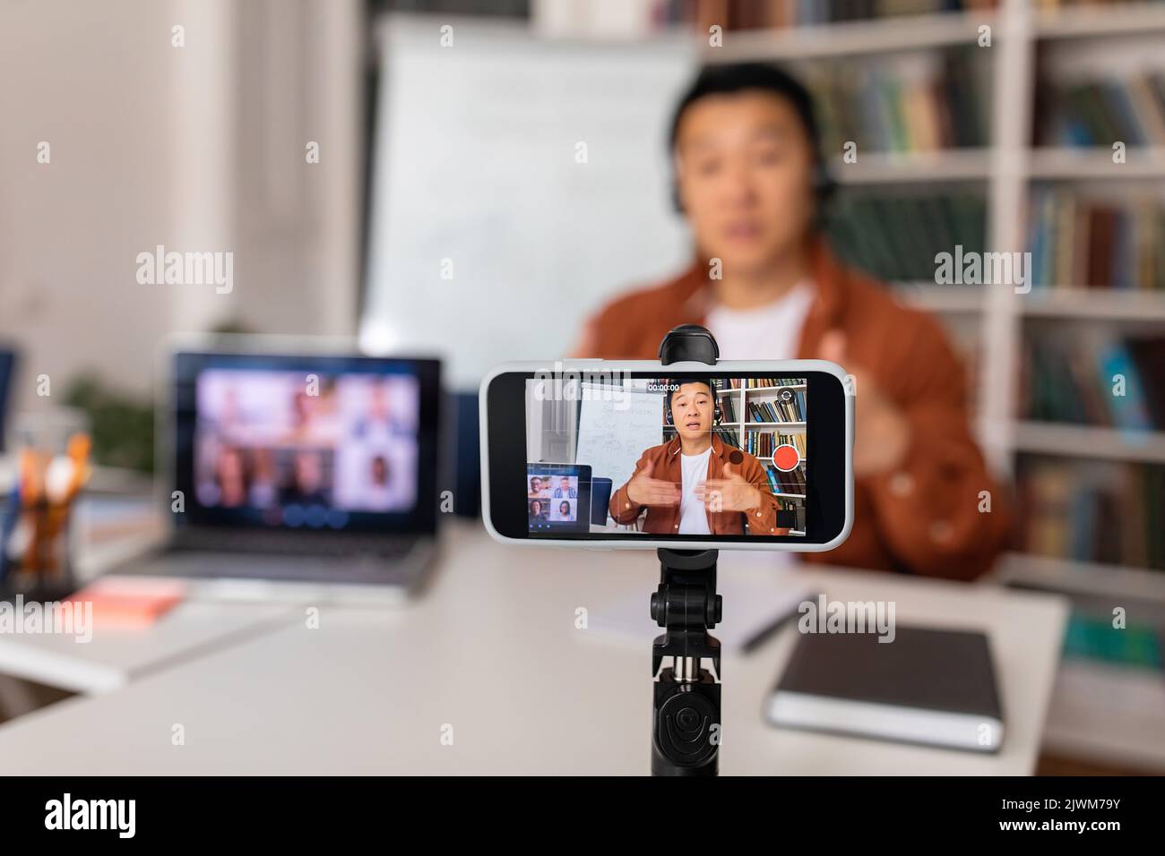 Asian Male Tutor Making Video Call Teaching Online In Library Stock ...