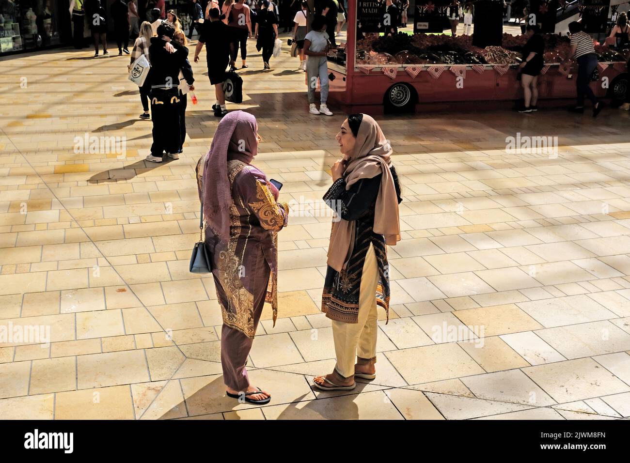 Two muslim women talking in a shopping centre in Bristol, UK Stock ...