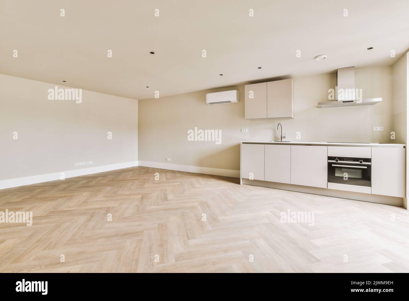 Interior of empty white kitchen with windows and wooden parquet floor ...