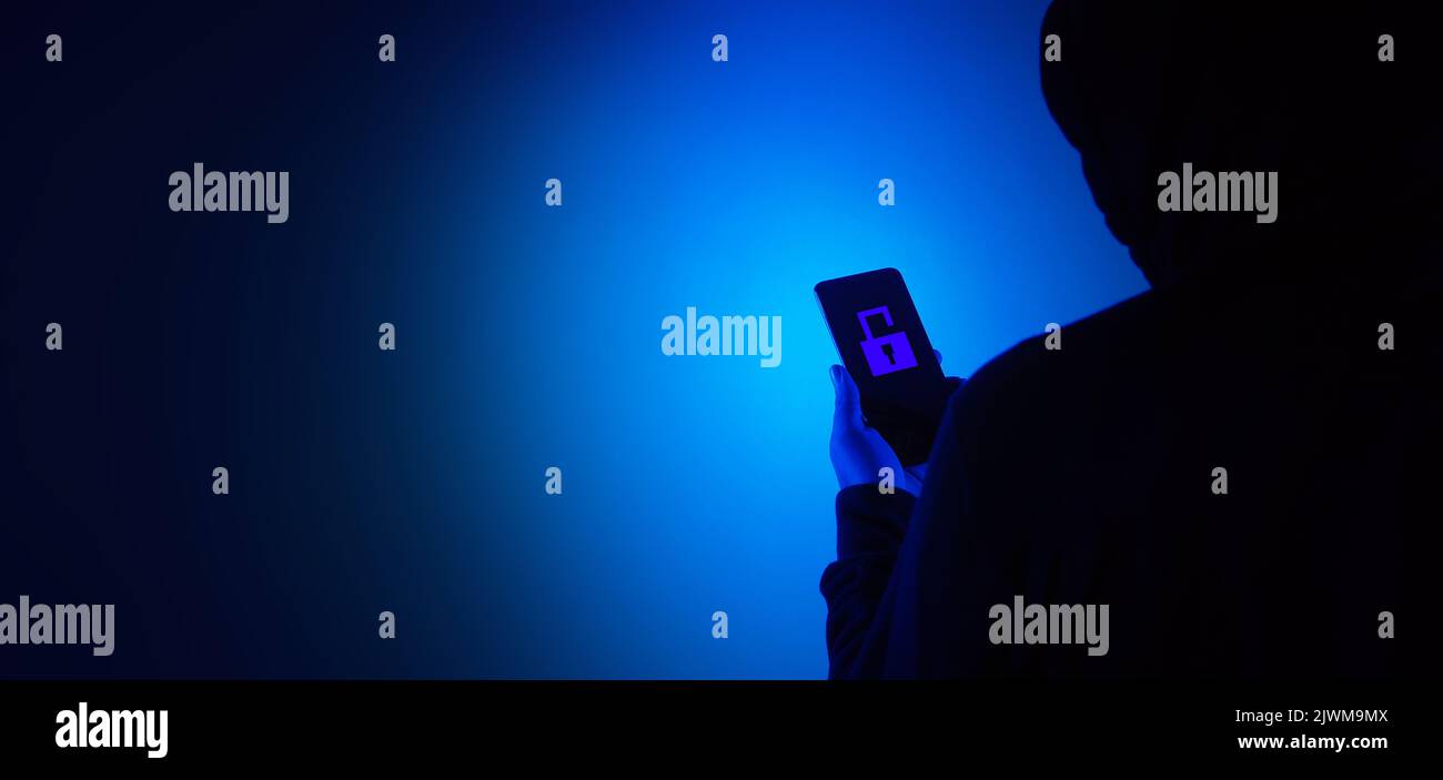 Digital security Concept. Anonymous hacker with mask holding smartphone ...