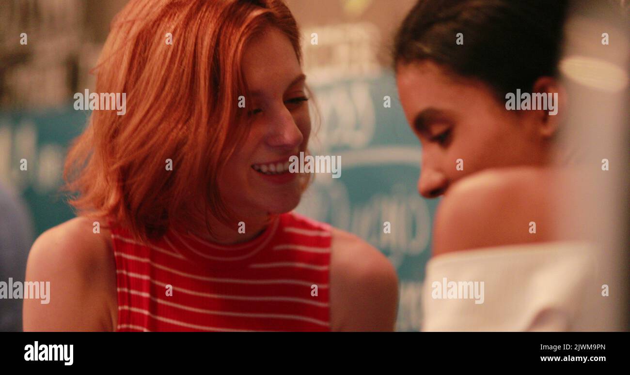 Friend showing cellphone screen to girlfriend at night Stock Photo - Alamy