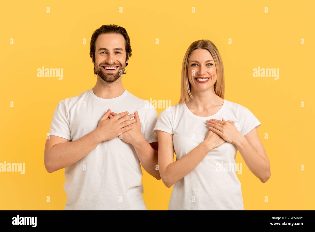 Smiling millennial caucasian family in white t-shirts press their hands ...