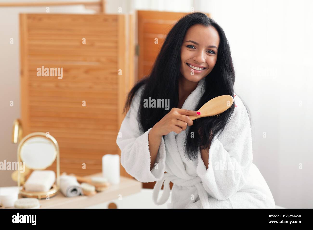 Lady Brushing Hair Smiling To Camera Using Brush In Bathroom Stock ...