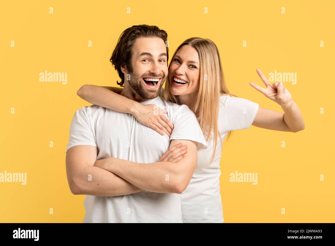 Cheerful millennial caucasian man with stubble and lady in white t ...