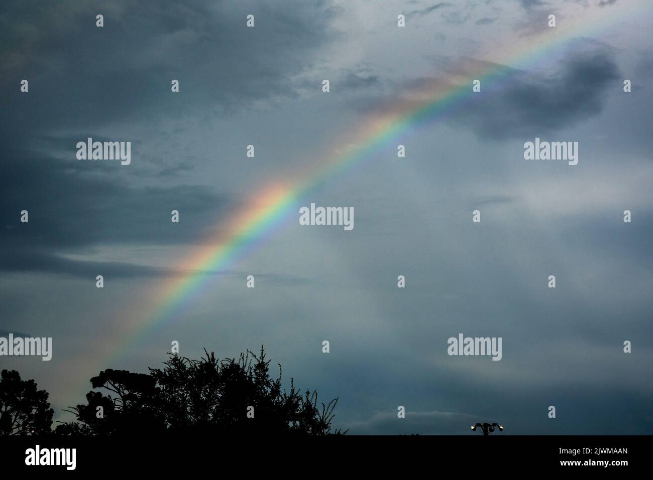 After a cloudy and stormy day, a rainbow starts to appear over North ...