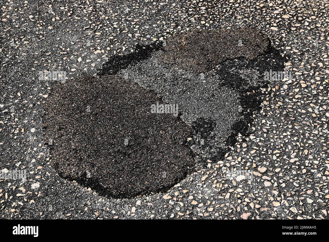 Patched road damage in city street in Lisbon, Portugal. Road ...