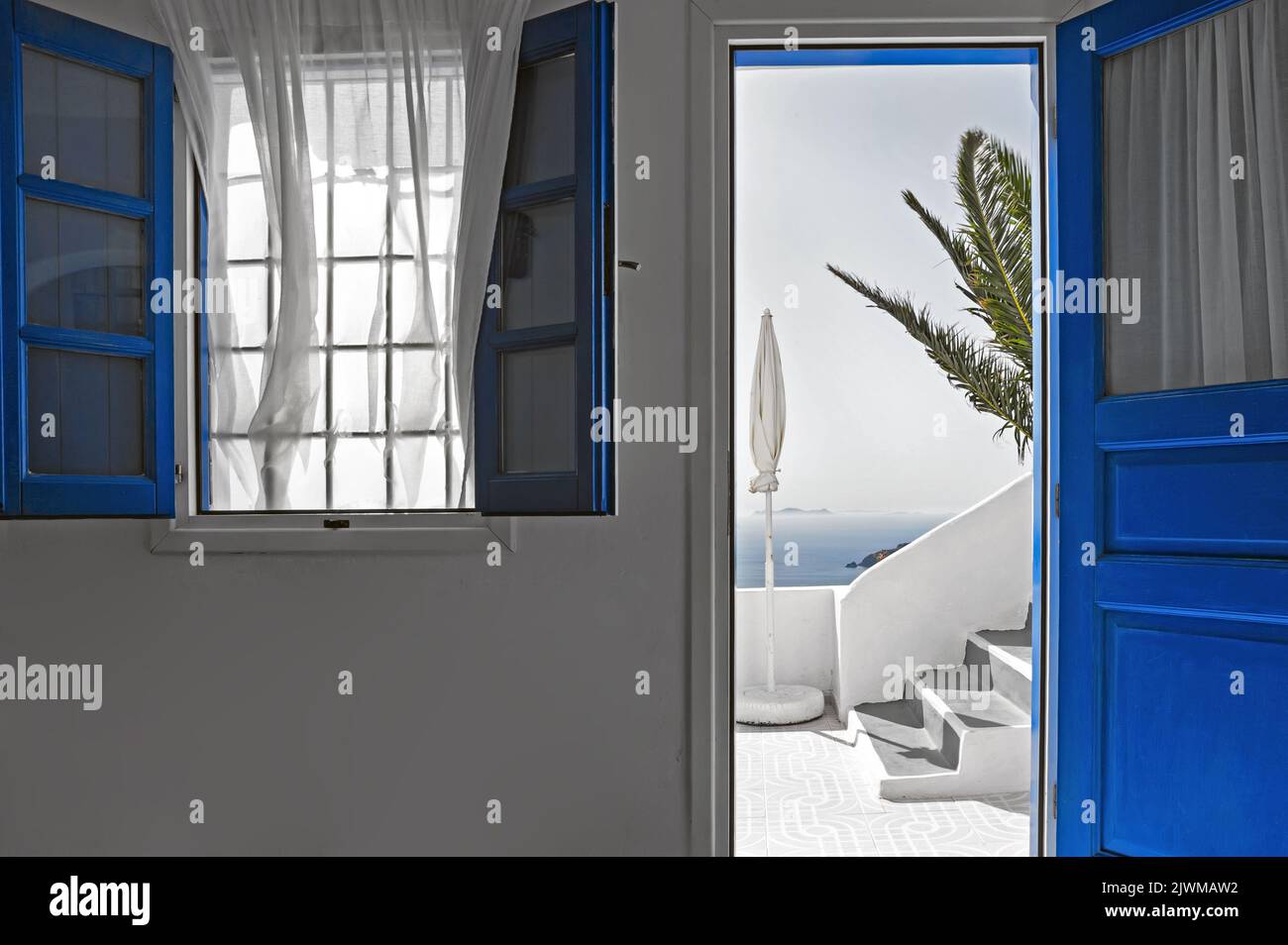 Window and the open door with caldera view in Imerovigli at Santorini ...