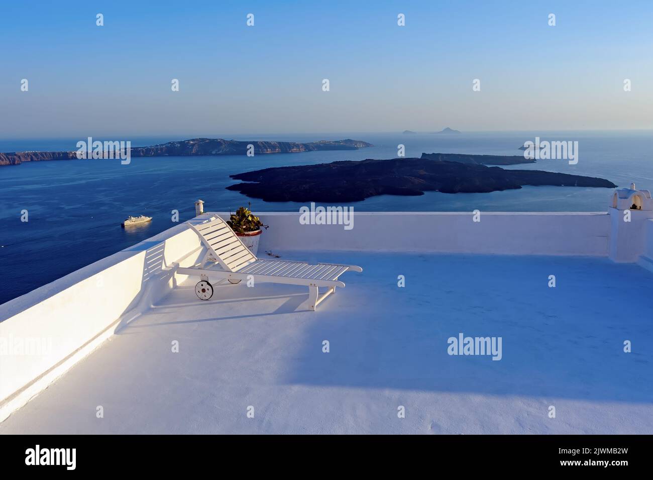 A lounge chair on the terrace with caldera view in Fira, Santorini ...