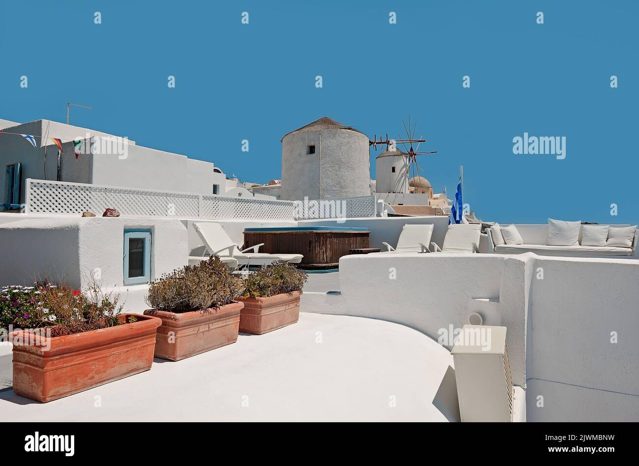The unidentified building of Oia with windmill at background on ...