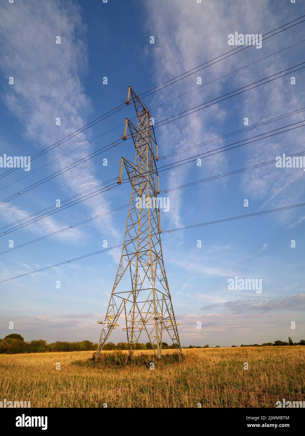 Electric power supply lines and pylon blue sky with light clouds Stock ...