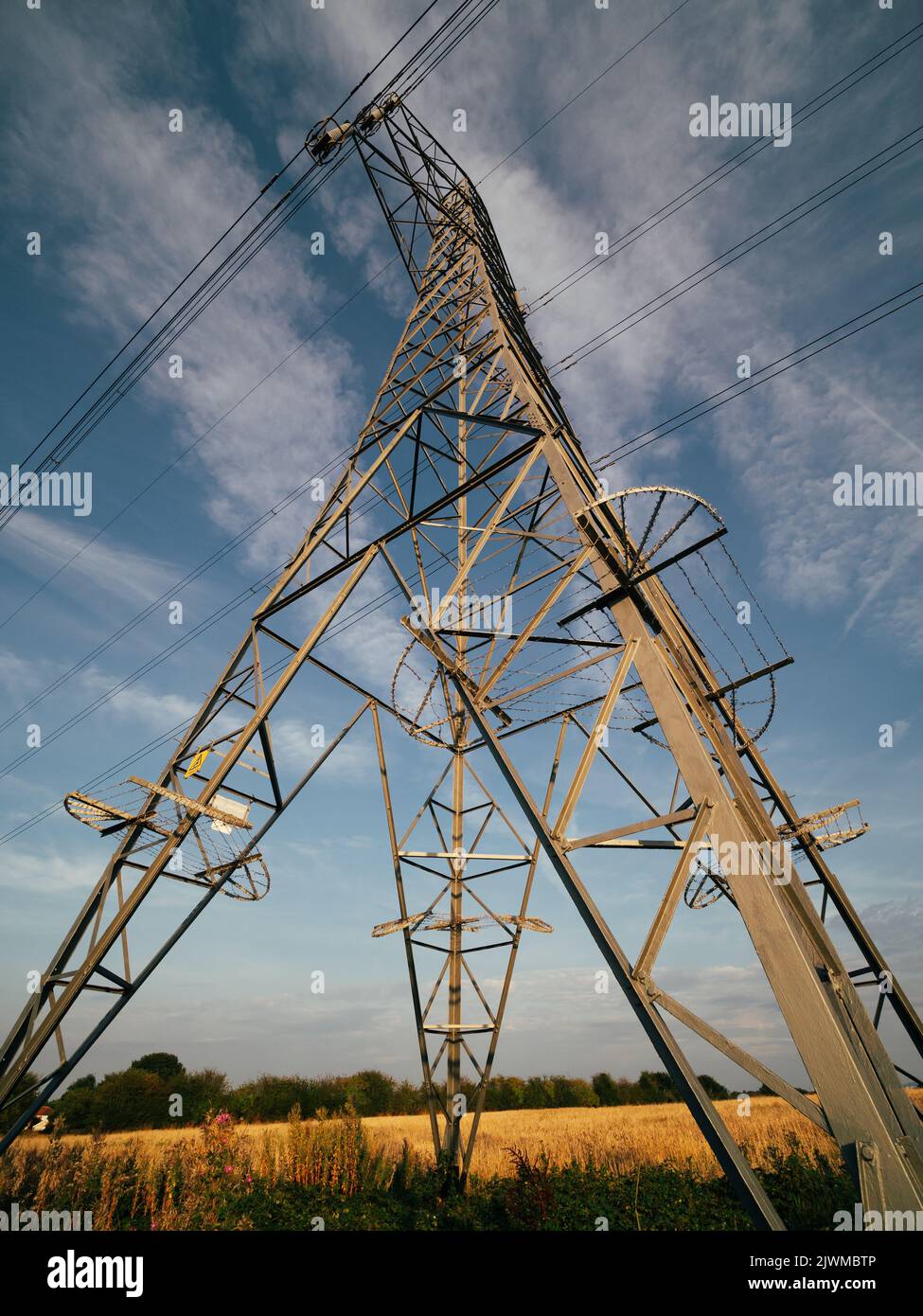 Electric power supply lines and pylon blue sky with light clouds Stock ...