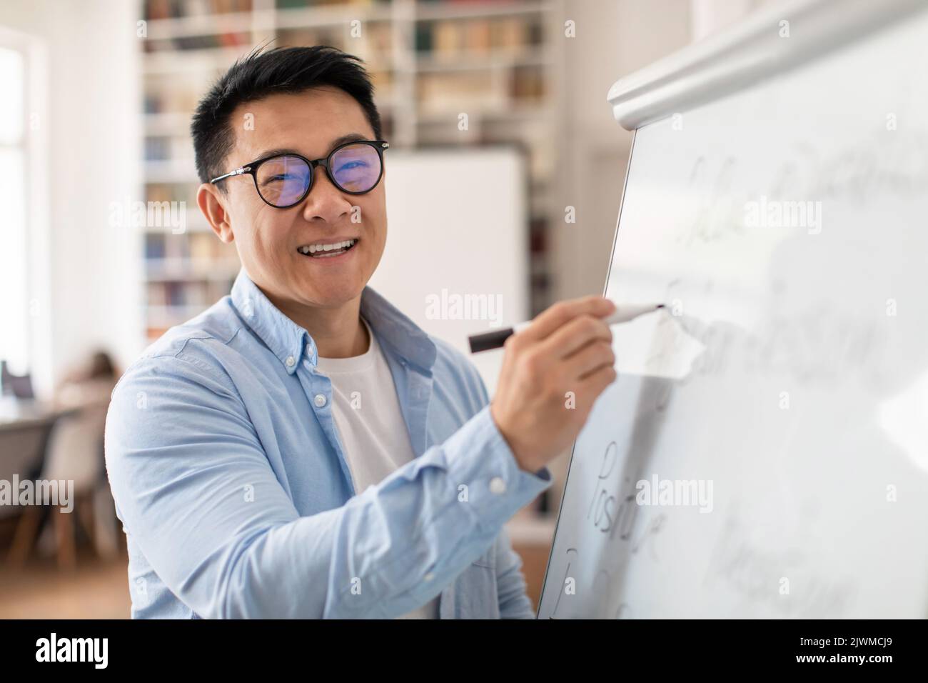Cheerful Chinese Tutor Smiling To Camera Standing In Classroom Stock ...