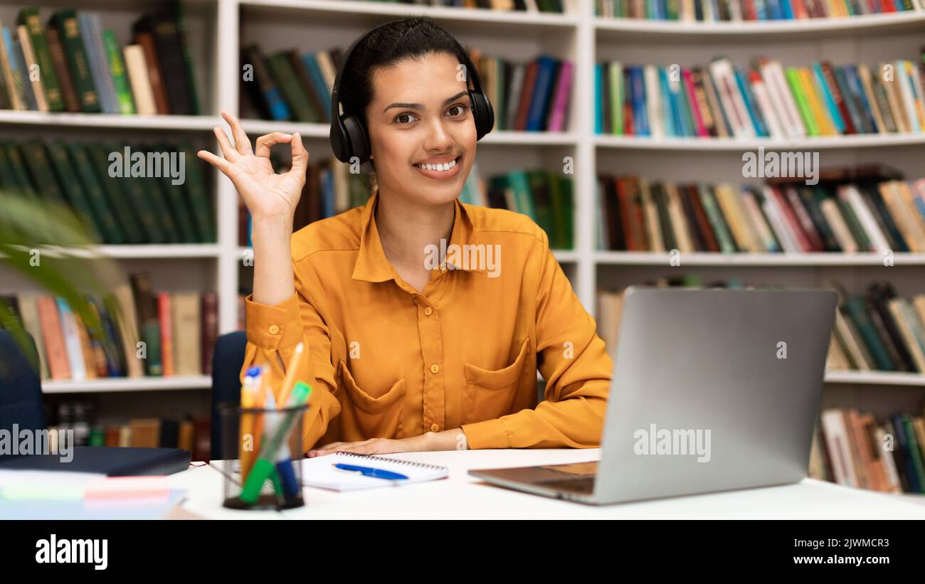 E-learning concept. Happy young female teacher giving online lesson on ...