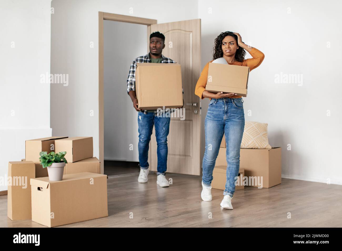 Disgusted Black Couple Entering New Bad House Carrying Moving Boxes ...