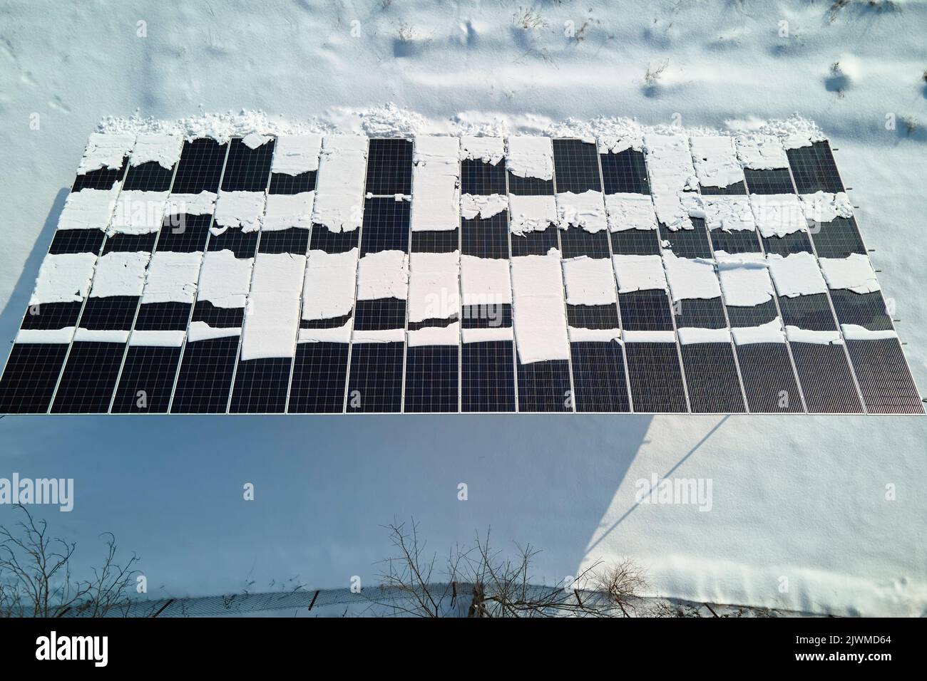 Aerial view of snow melting from covered solar photovoltaic panels at ...