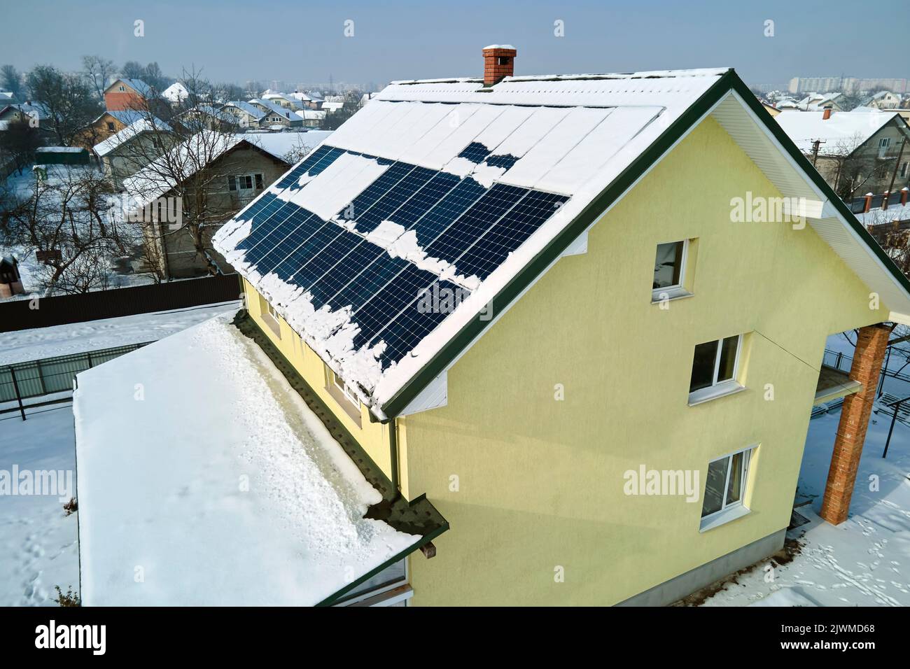 Aerial view of snow melting from covered solar photovoltaic panels ...