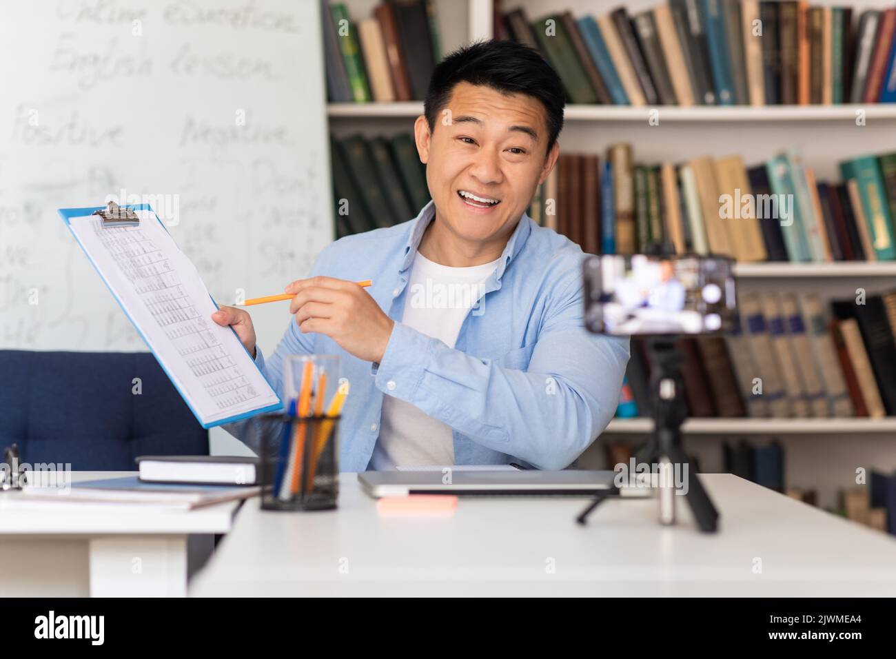Korean Male Teacher Having Virtual Lecture Talking To Cellphone Indoor ...