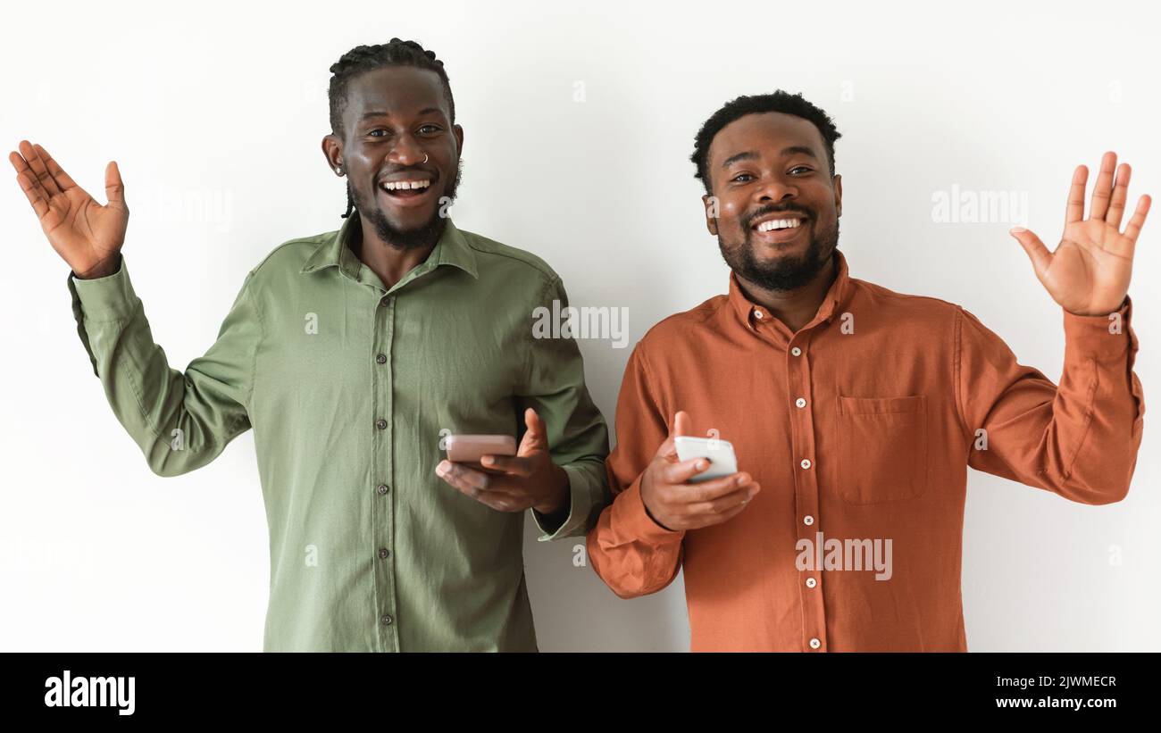 Two Black Guy Using Smartphones Waving Hands, White Background ...