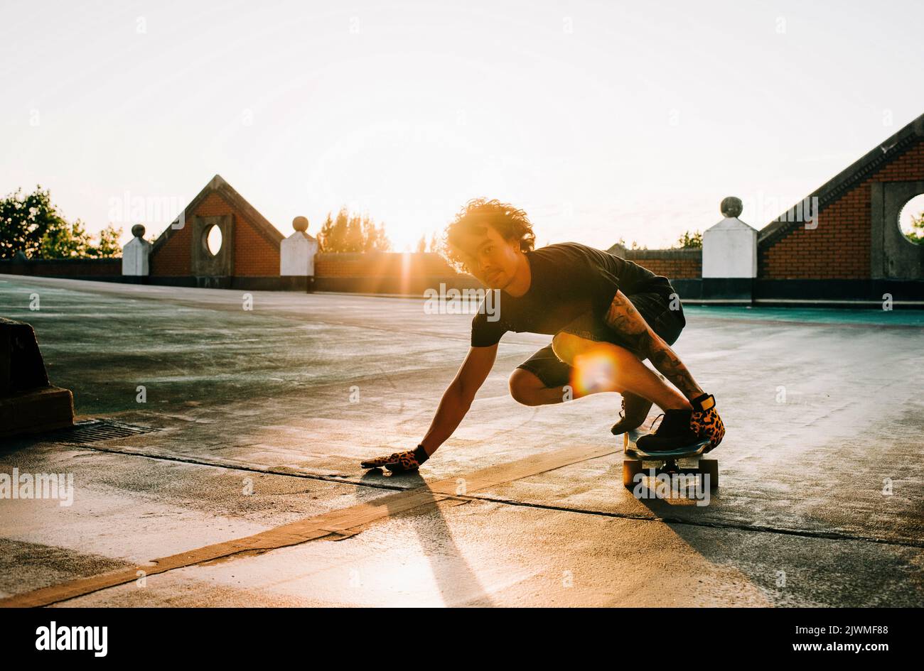 portrait of a man skateboarding in a car park at sunset Stock Photo - Alamy