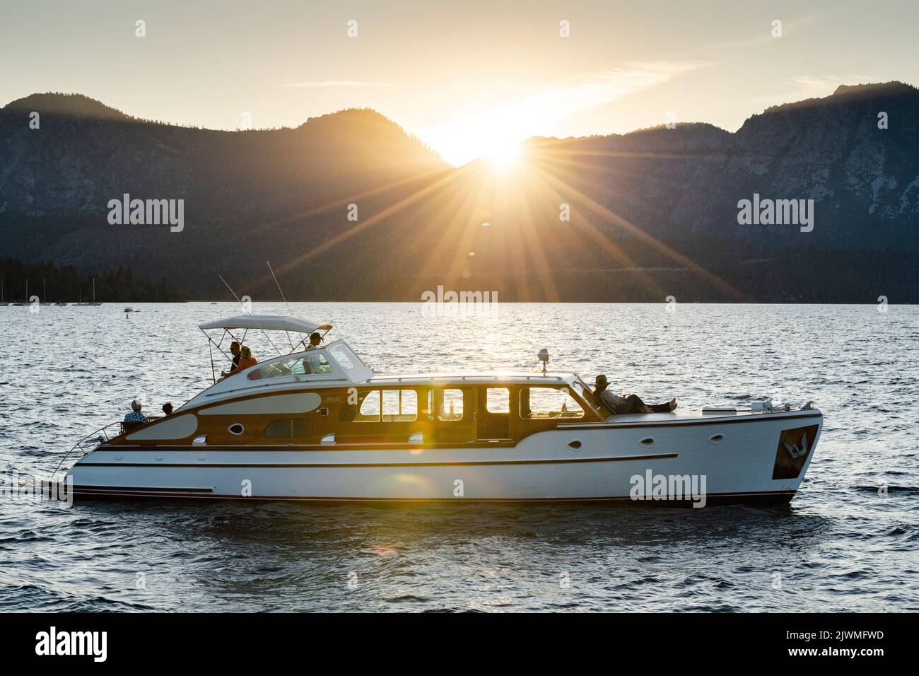A luxurious yacht cruises during sunset Stock Photo - Alamy