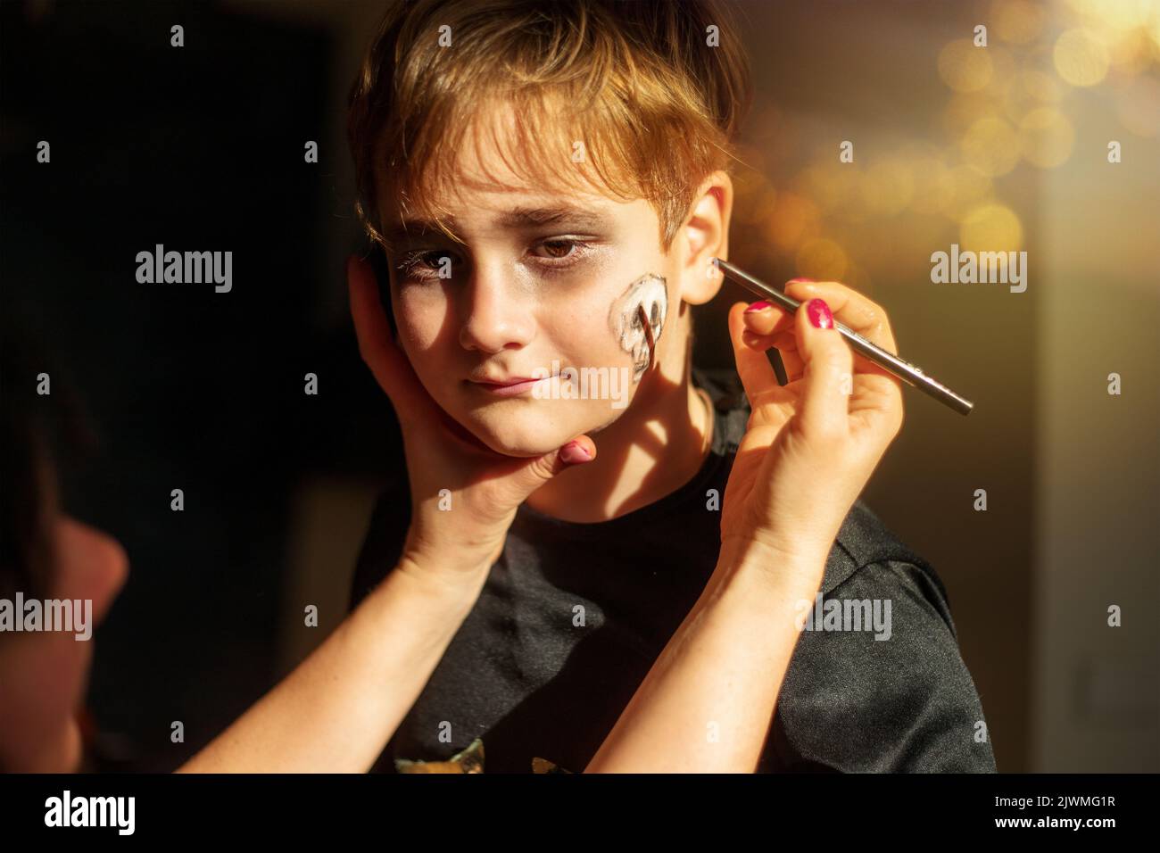 animator draws cobwebs on boy's face on halloween Stock Photo - Alamy