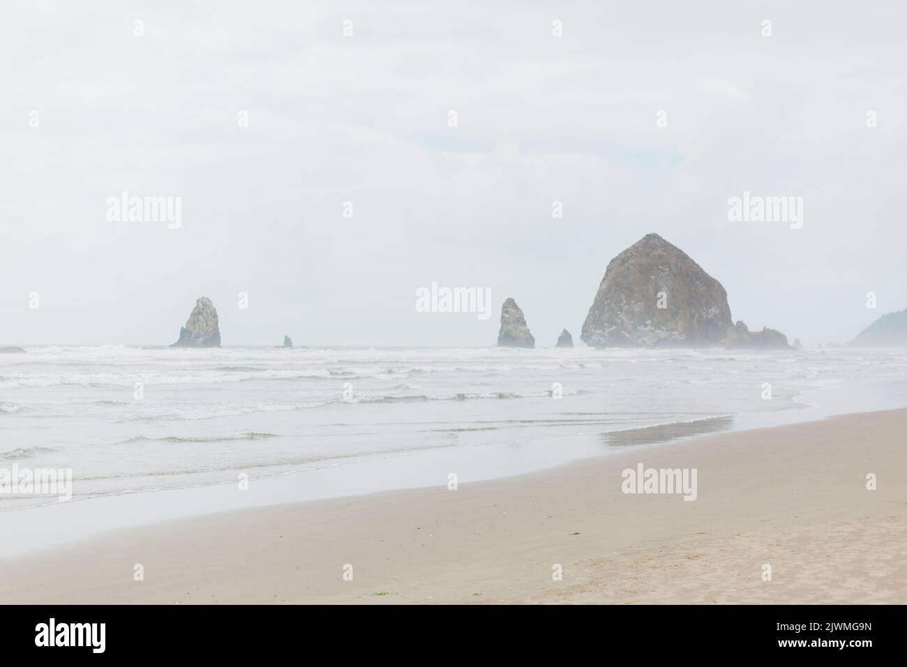 Landscape view of Cannon Beach, Oregon on an overcast day Stock Photo ...