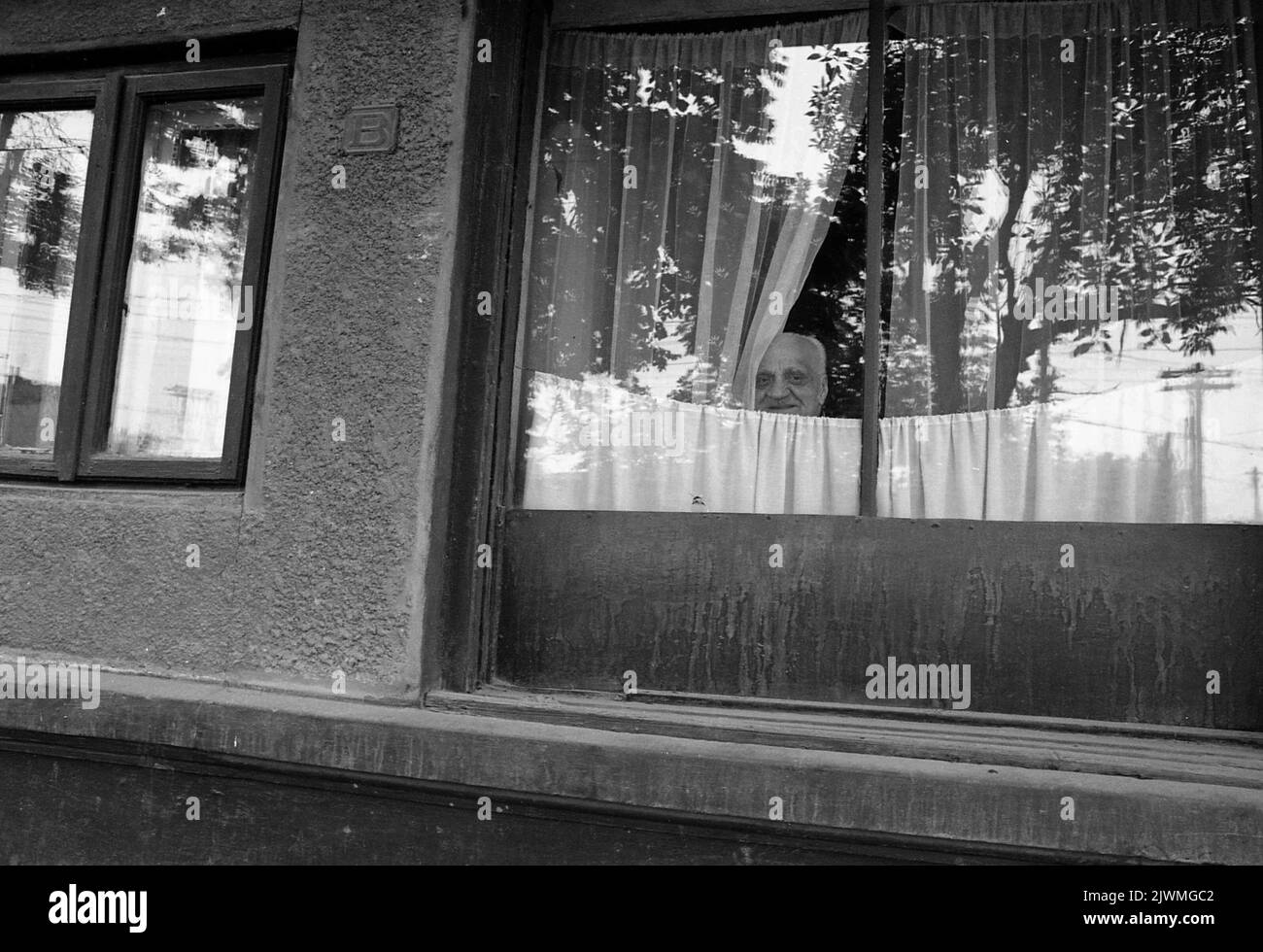 Old man looking out of window Black and White Stock Photos & Images - Alamy