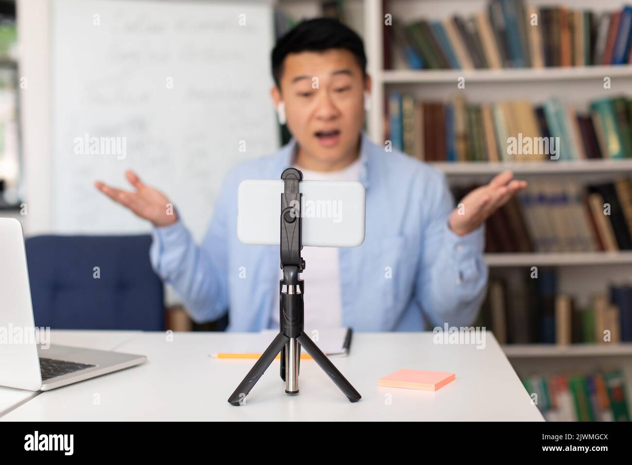 Asian Male Teacher Talking To Smartphone Having Online Class Indoor ...