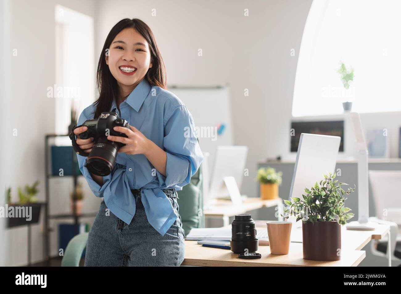 Asian young woman posing photographer hi-res stock photography and ...