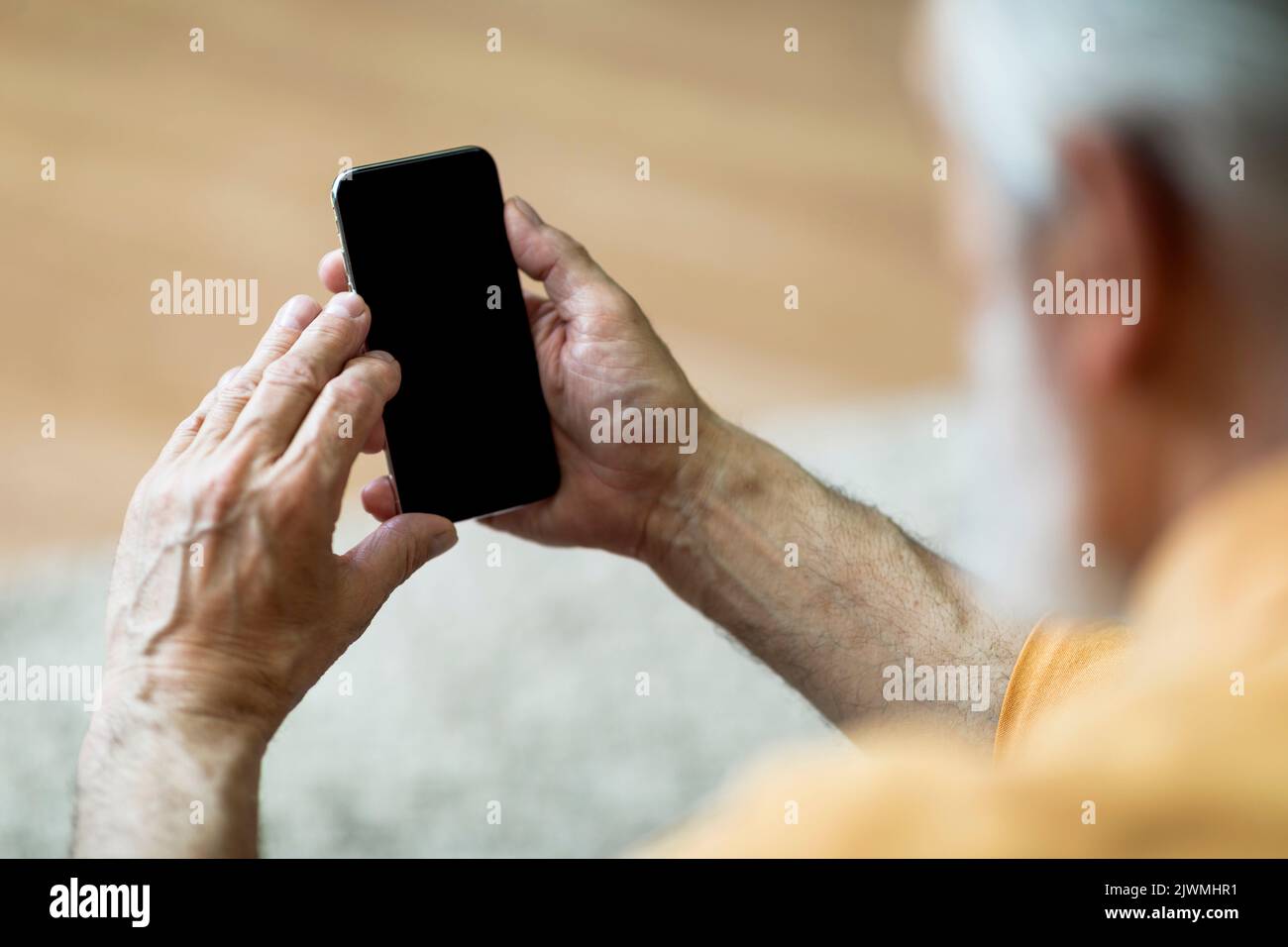 Smartphone with black empty screen in mature man hand, mockup Stock ...