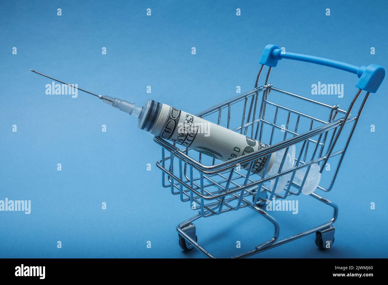 The syringe wrapped in a dollar is in the basket. Offering a financial ...