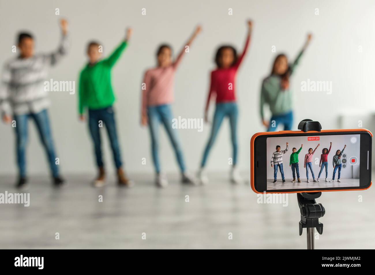 Group Of Kids Filming Video For Blog Via Smartphone Indoors Stock Photo ...