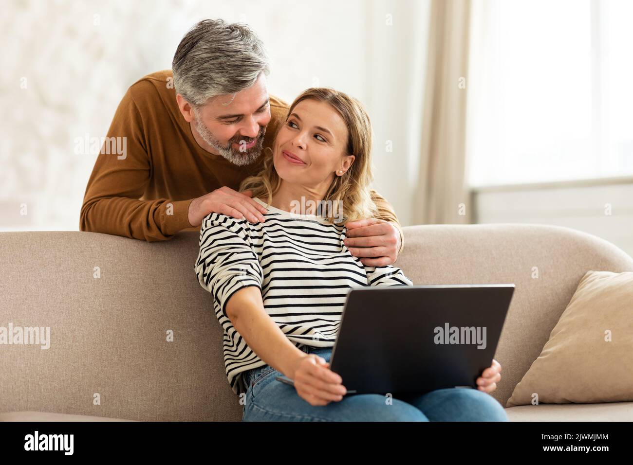 Happy Middle Aged Couple Using Laptop Computer At Home Stock Photo - Alamy