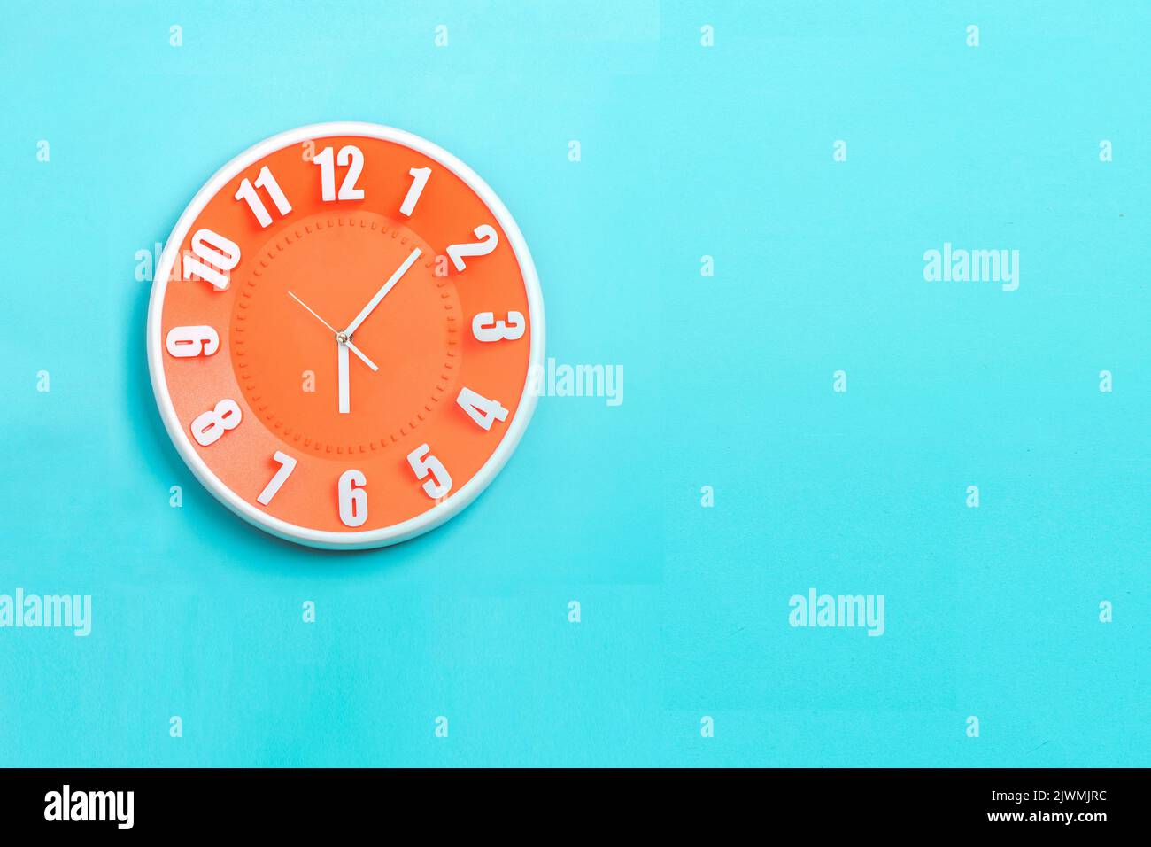 beautiful Orange wall clock on blue background ,concept of Start the ...