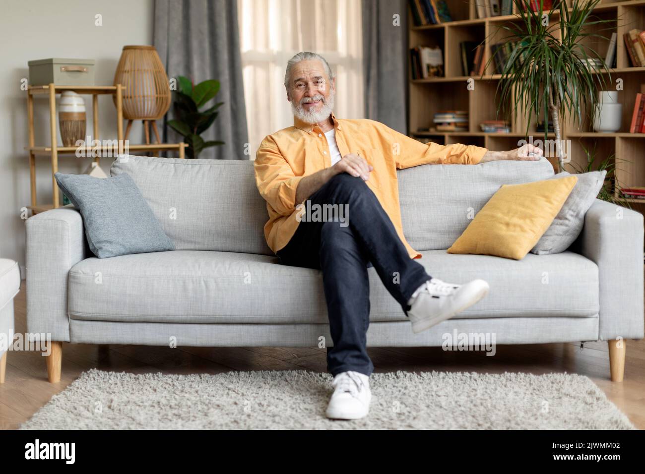 Senior man sitting on couch hi-res stock photography and images - Alamy