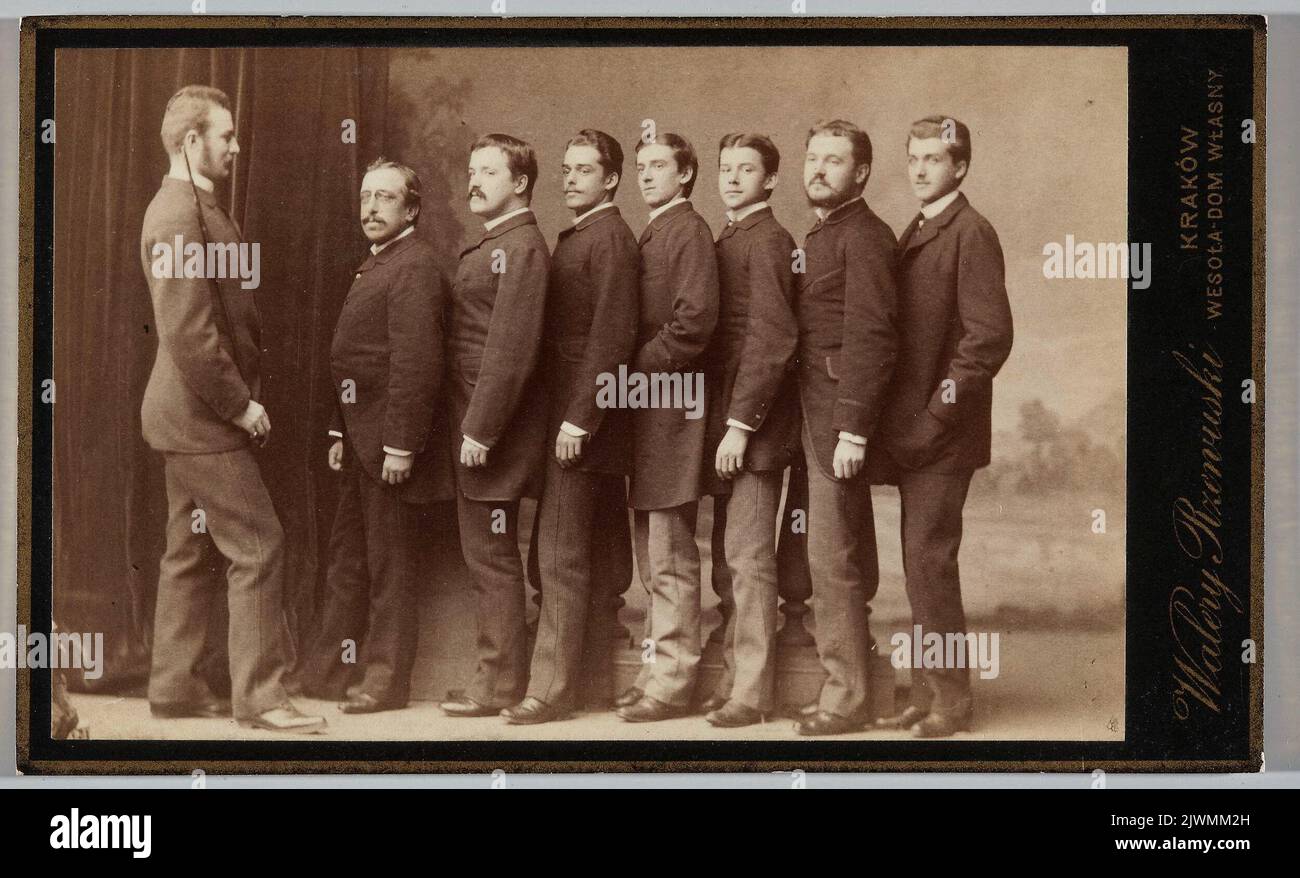 Photograph of eight men standing ‘in an even line, by height ...