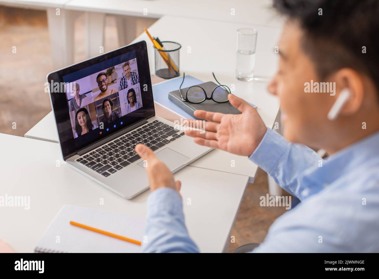 Japanese Male Teacher Video Calling Via Laptop Teaching Students Indoor ...