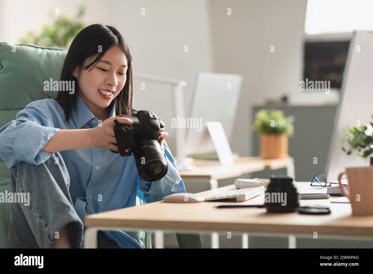 Chinese Photographer Lady Working Holding Camera Sitting In Photo ...