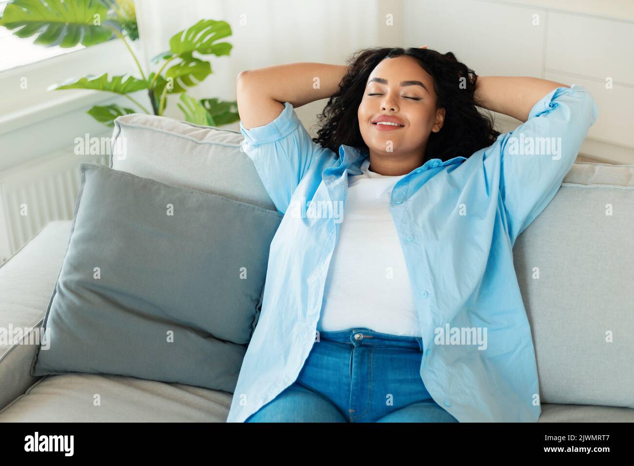 Relaxed African American Female Resting Sitting On Couch At Home Stock ...