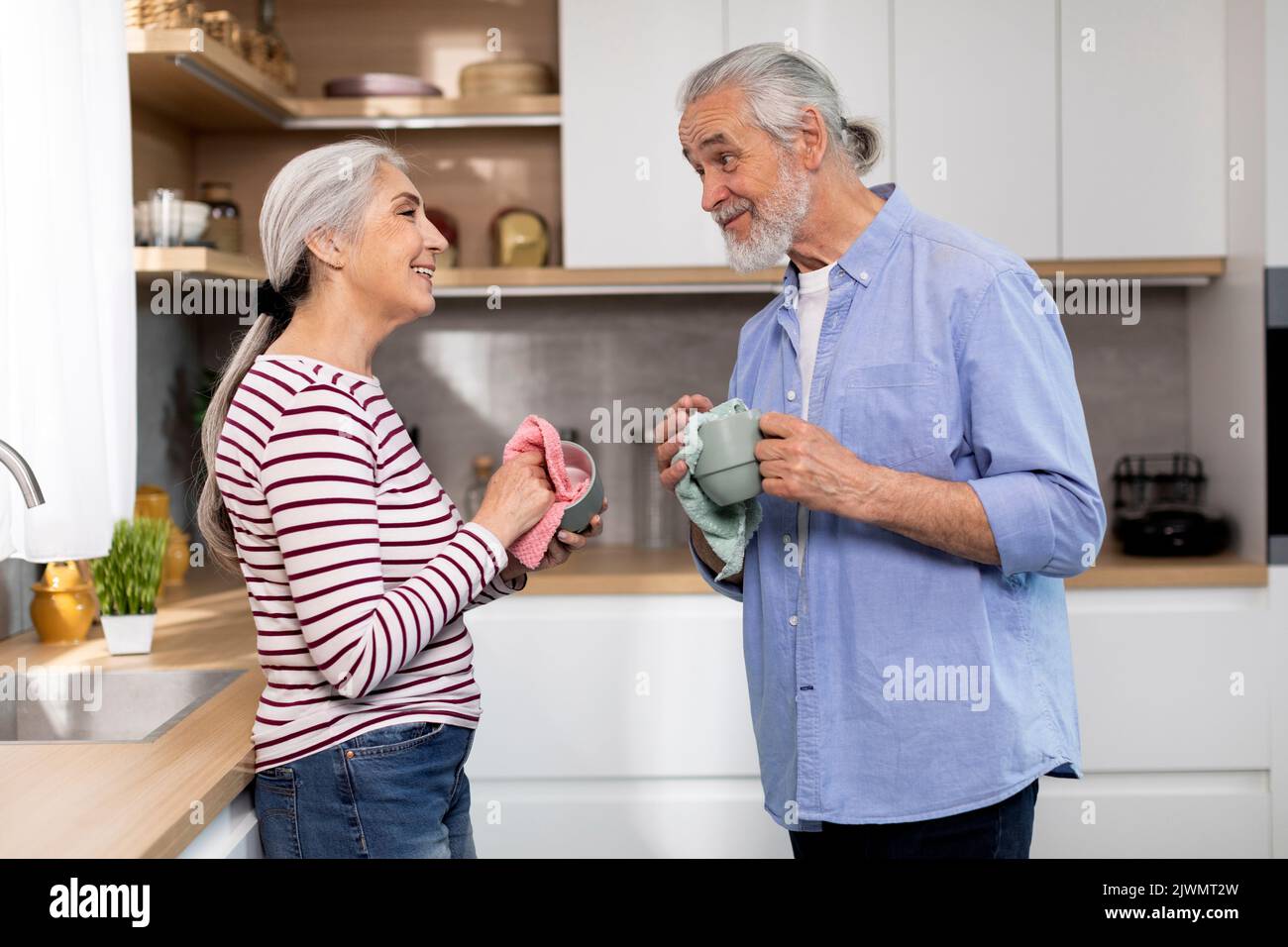 Happy Senior Spouses Sharing Domestic Chores, Wiping Dishes Together In ...