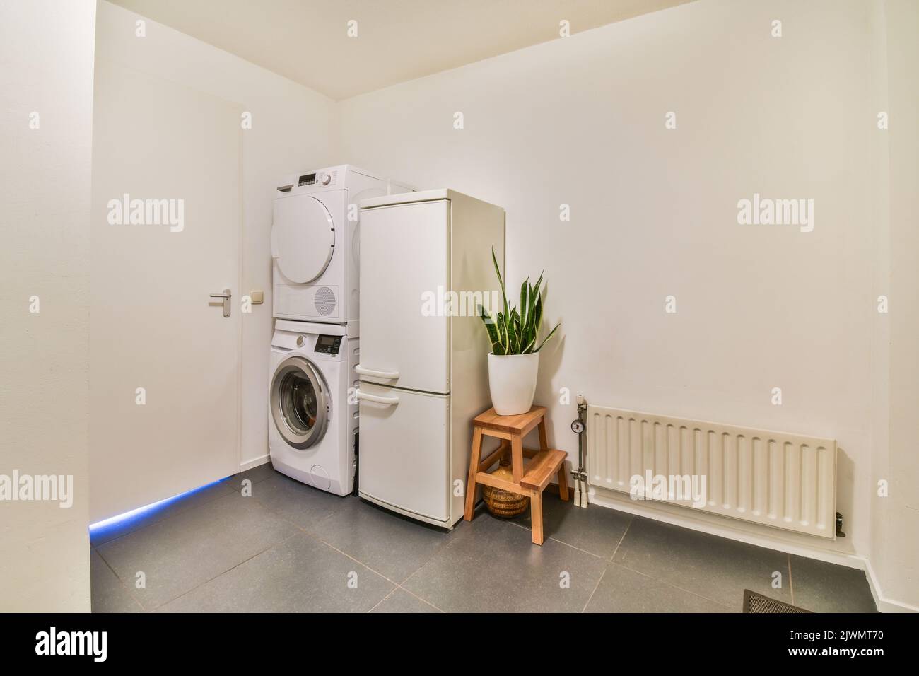 Interior of modern bright laundry room with white walls and dark ...