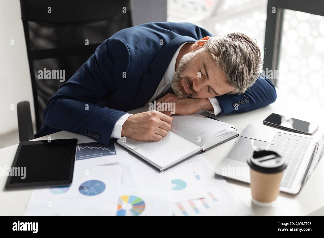 Overworked Middle Aged Businessman Napping At Workplace In Office Stock ...
