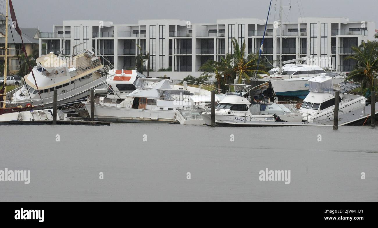 Boats are wrecked up against waterfront apartments at the Port ...