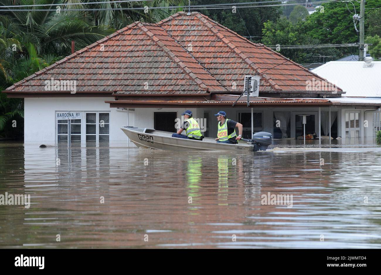 Police patrol flooded streets in the central Brisbane suburb of Rosalie ...