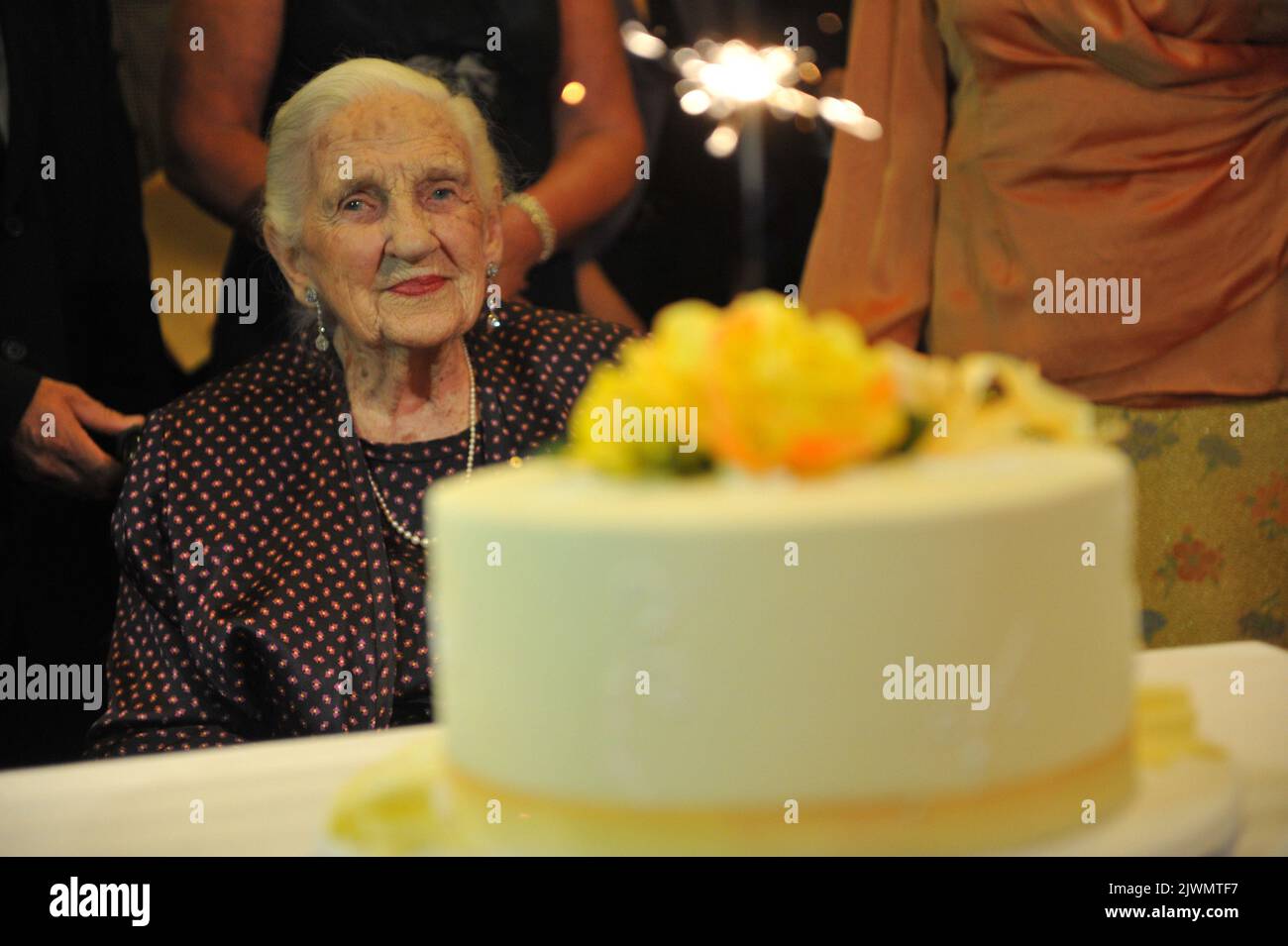 Dame Elisabeth Murdoch looks at her 102nd birthday cake at the ...