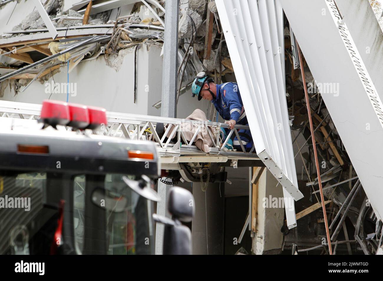 A woman is rescued after spending a night trapped in a building that ...